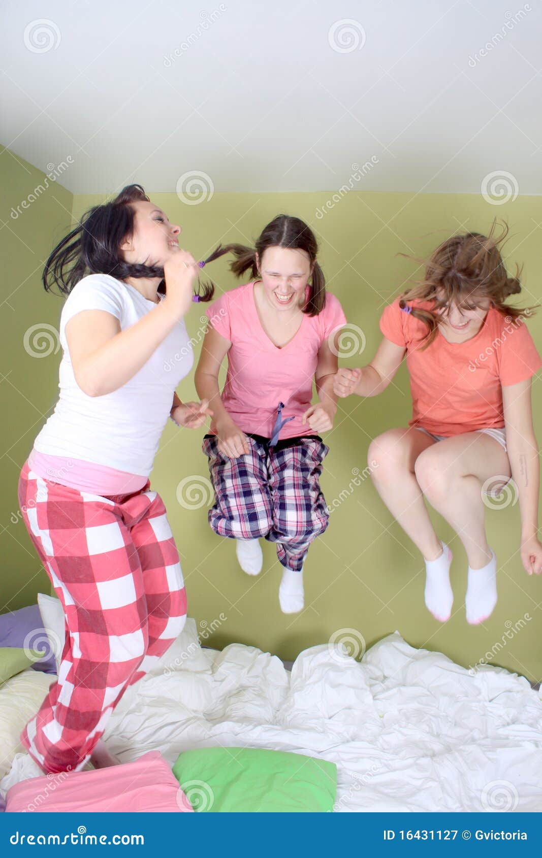 Girls jumping on bed stock image. Image of playing, females - 16431127