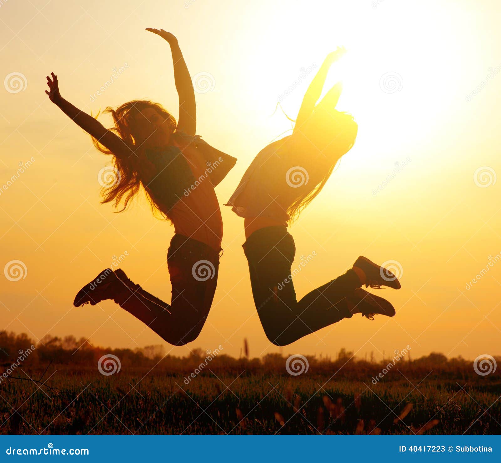 Girls jumping over sunset stock image. Image of enjoy - 40417223