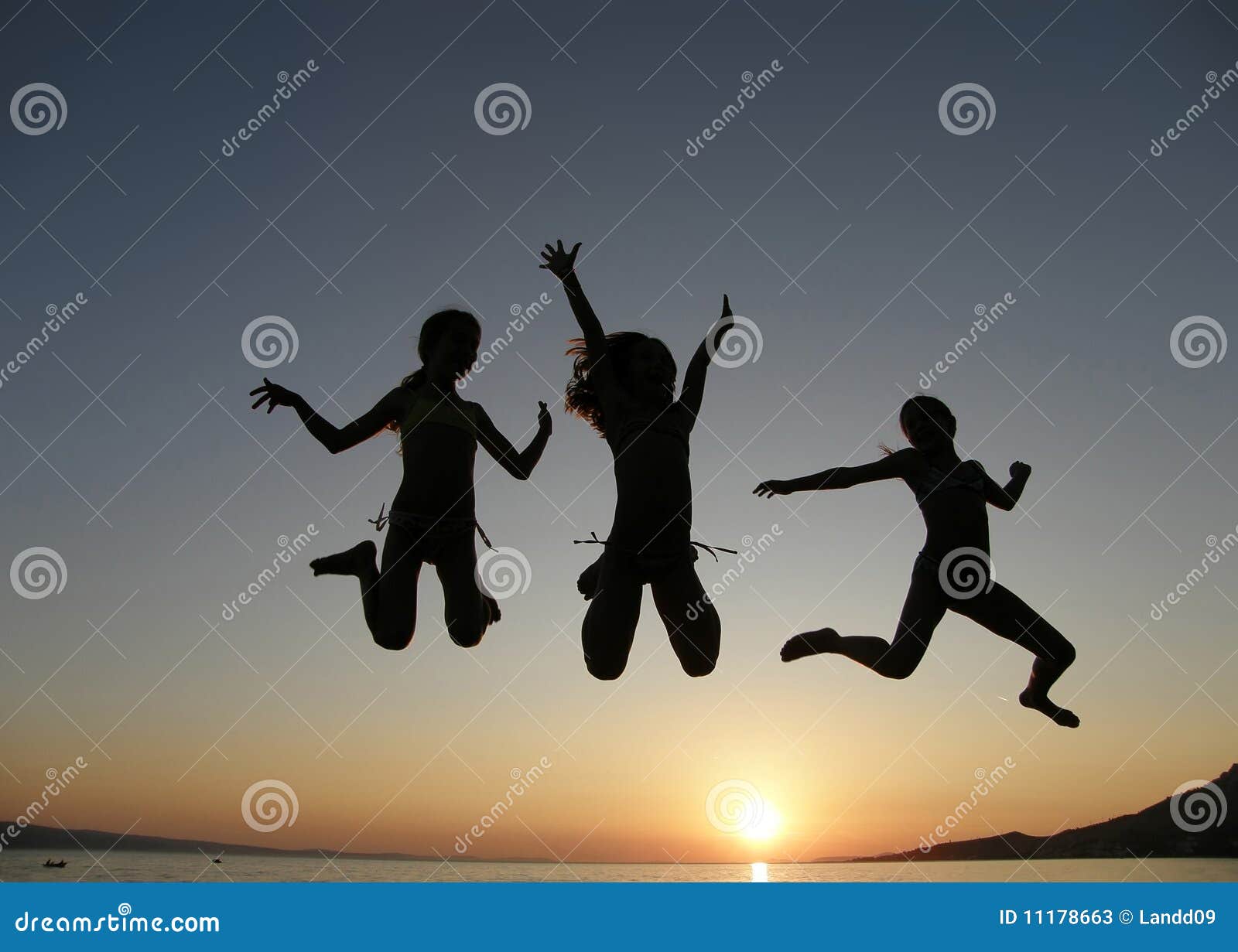 Girls jumping in sunset stock image. Image of euphoria - 11178663