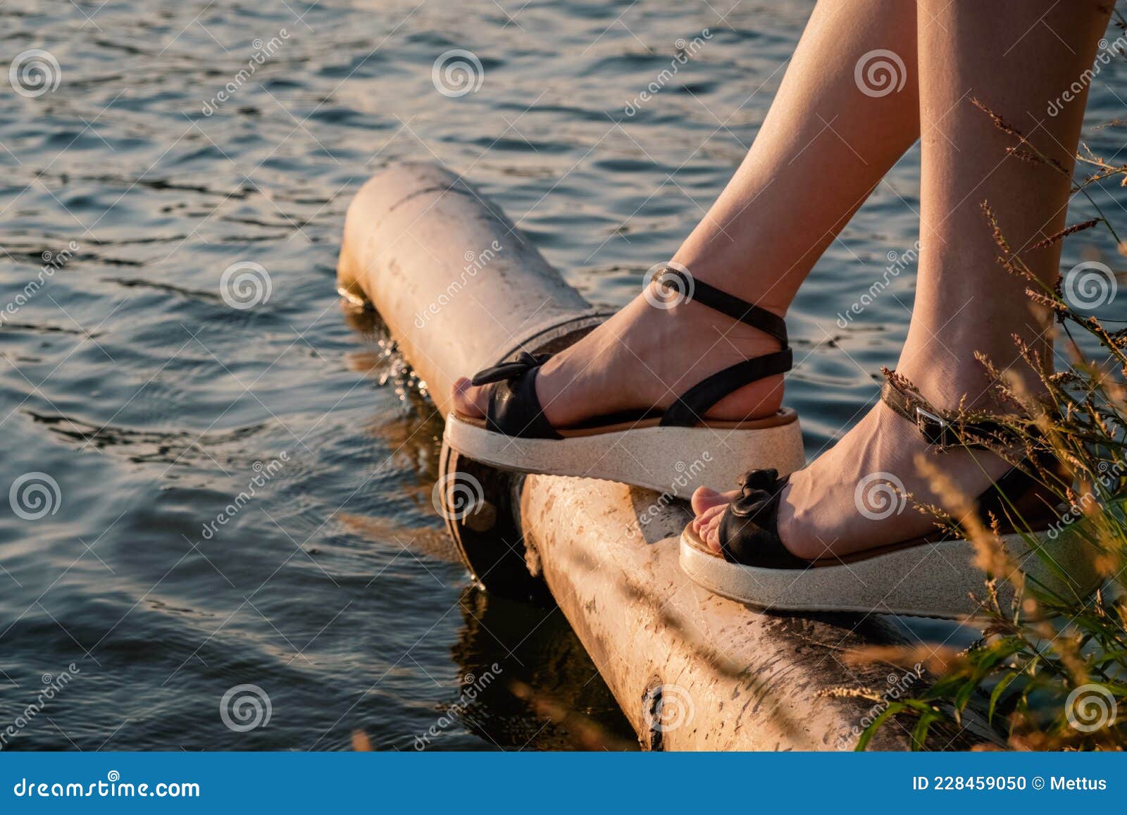 Girls Legs Resting on the Pier with Her Feet Placed on Rusty Pipe Stock ...