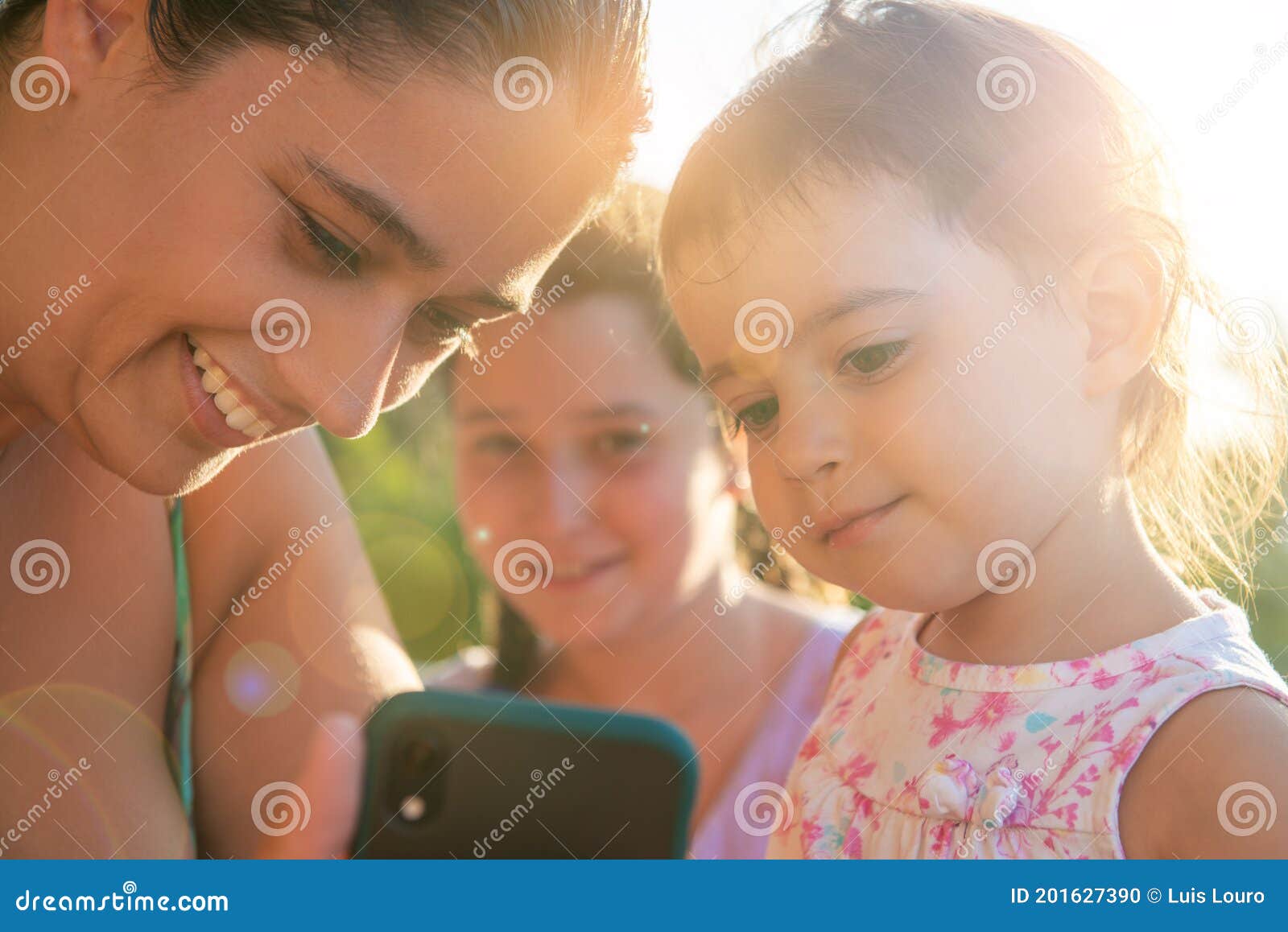 Girls looking at a phone stock photo. Image of cheerful - 201627390