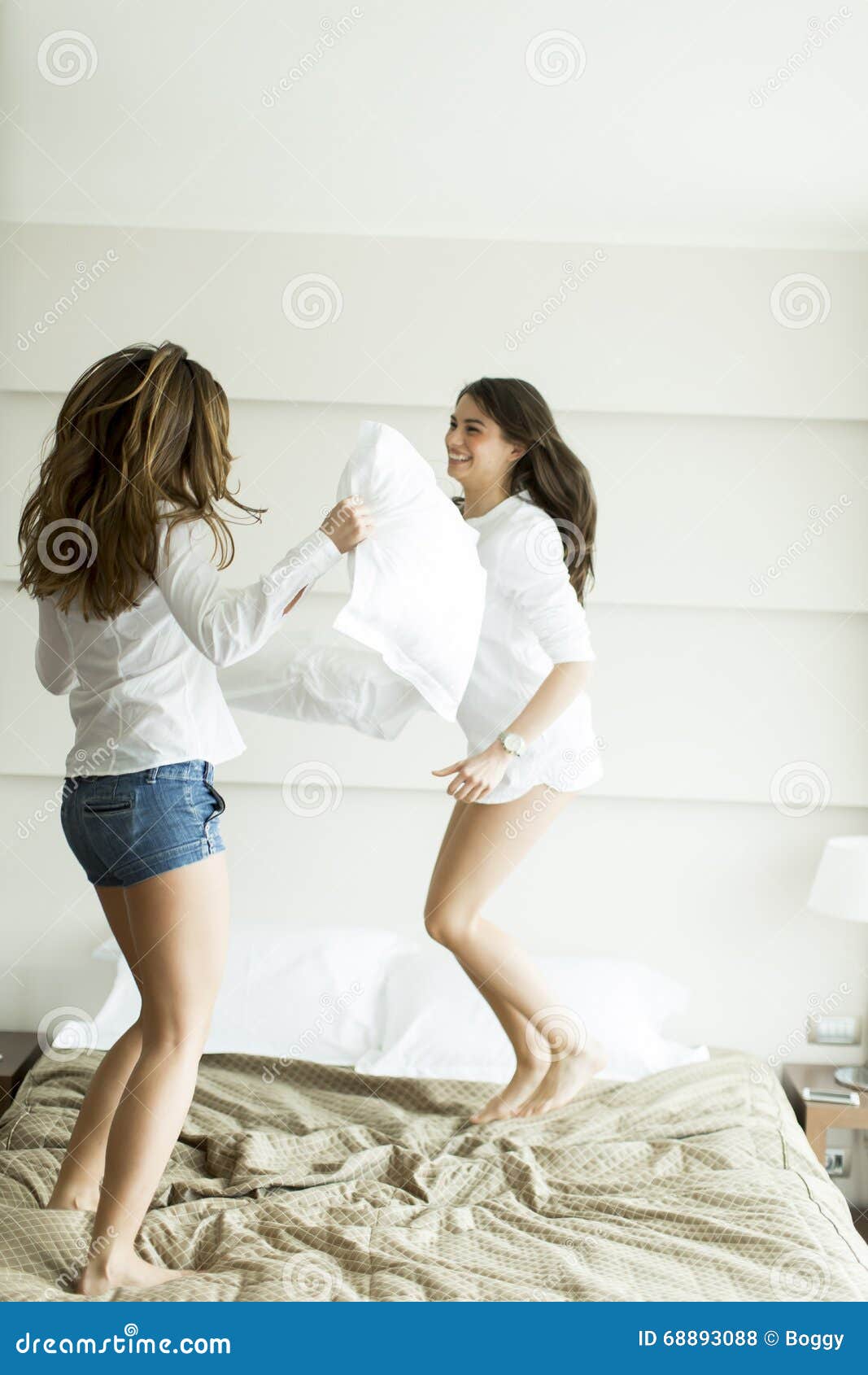 Girls in a pillow fight stock photo. Image of fight, cheerful - 68893088