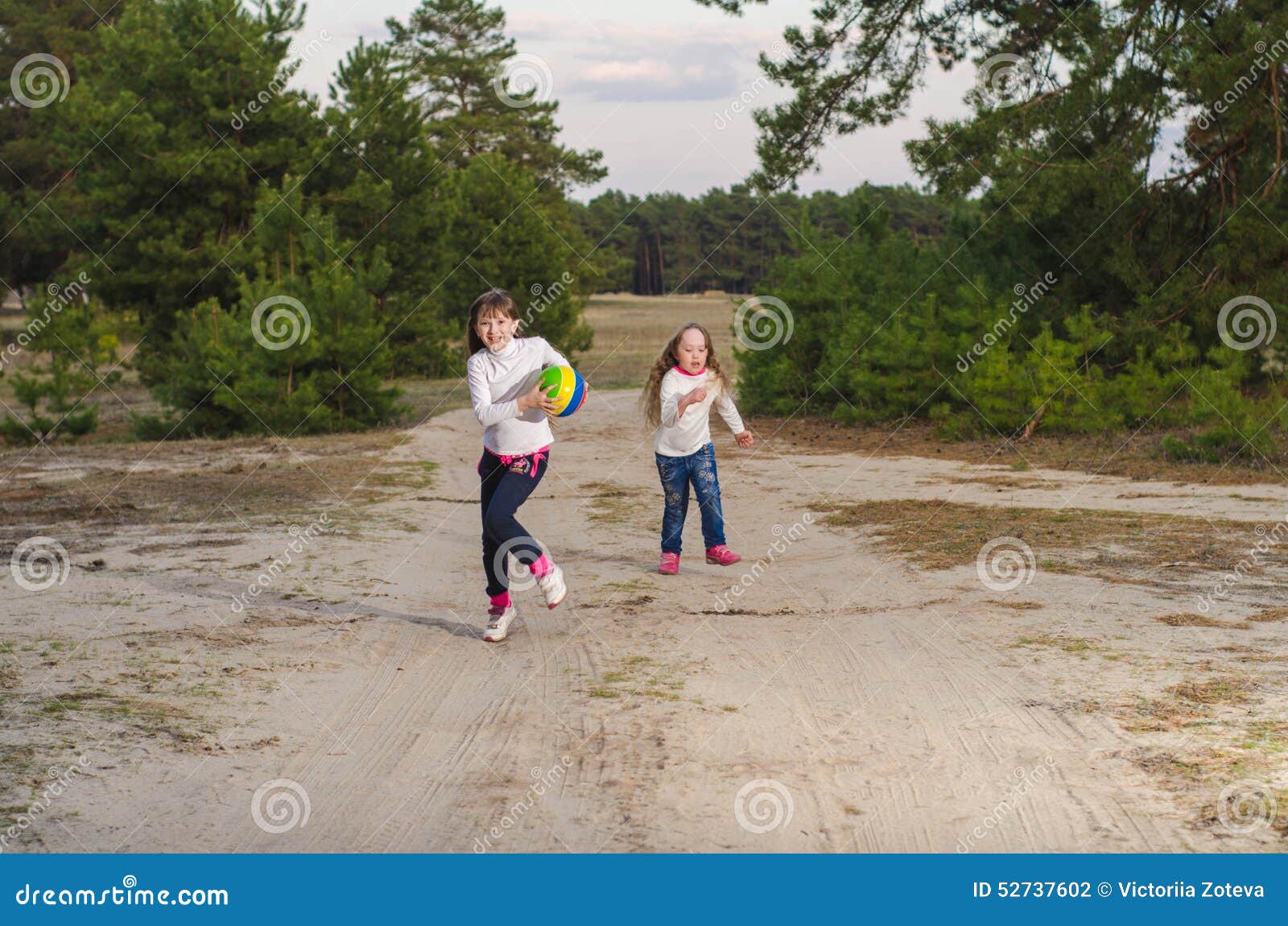 Girls playing with a ball stock photo. Image of road - 52737602