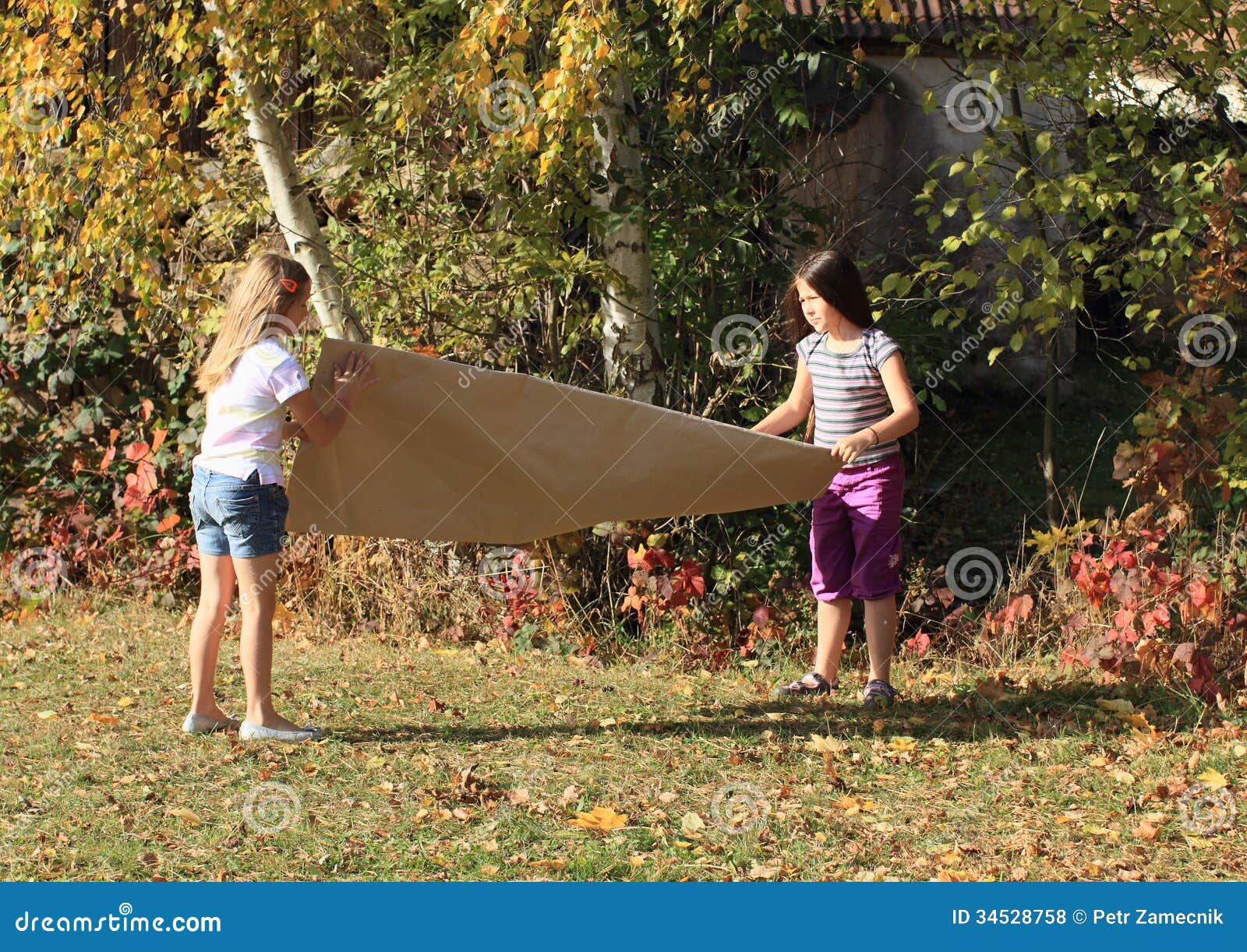 Girls playing with paper stock photo. Image of playing - 34528758