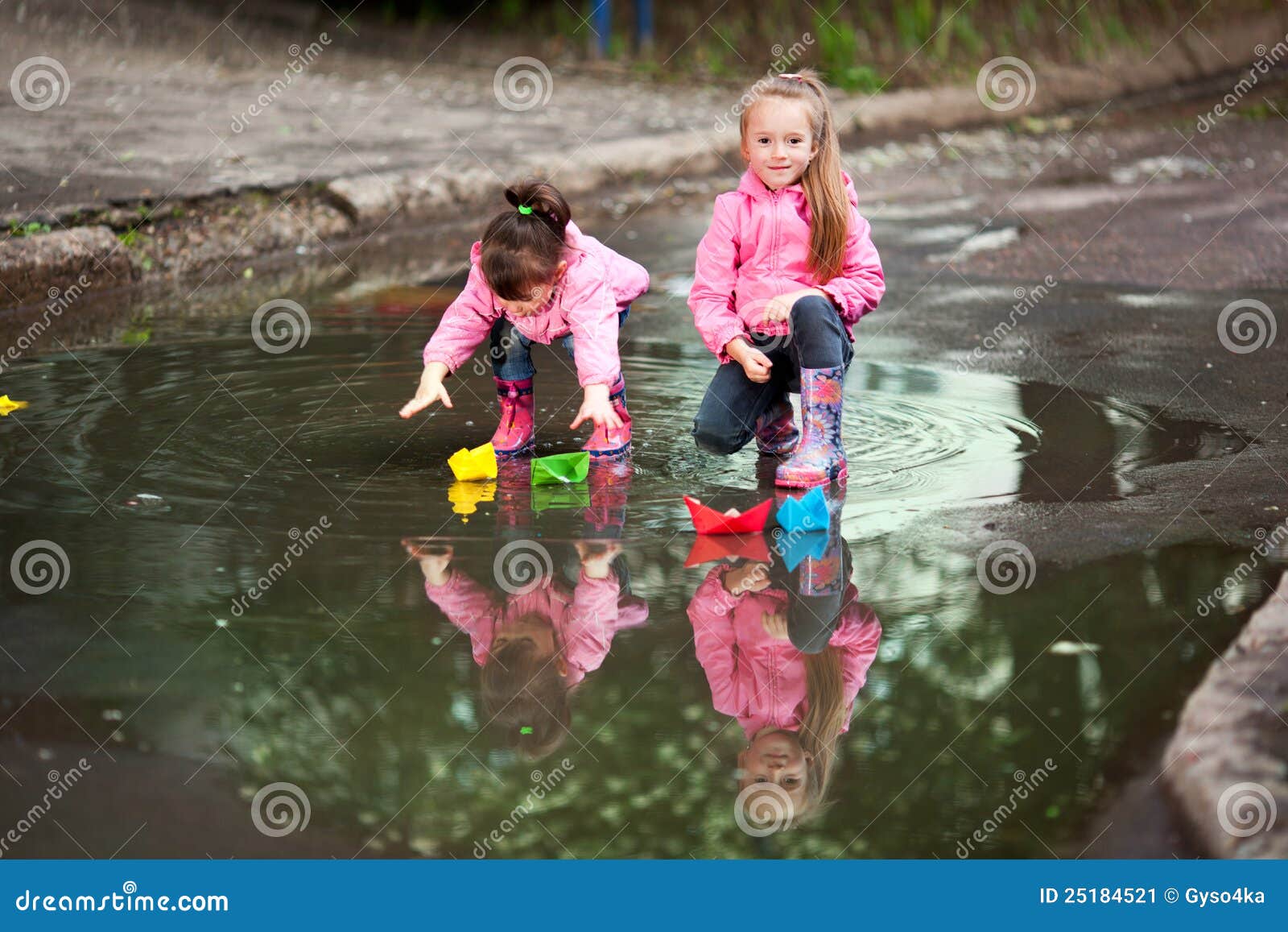 Girls playing in puddle stock image. Image of messy, paper - 25184521