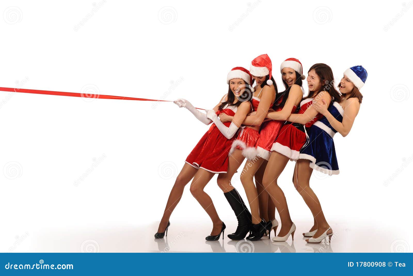Girls Pull Red Ribbon in Christmas Costumes Stock Photo - Image of ...