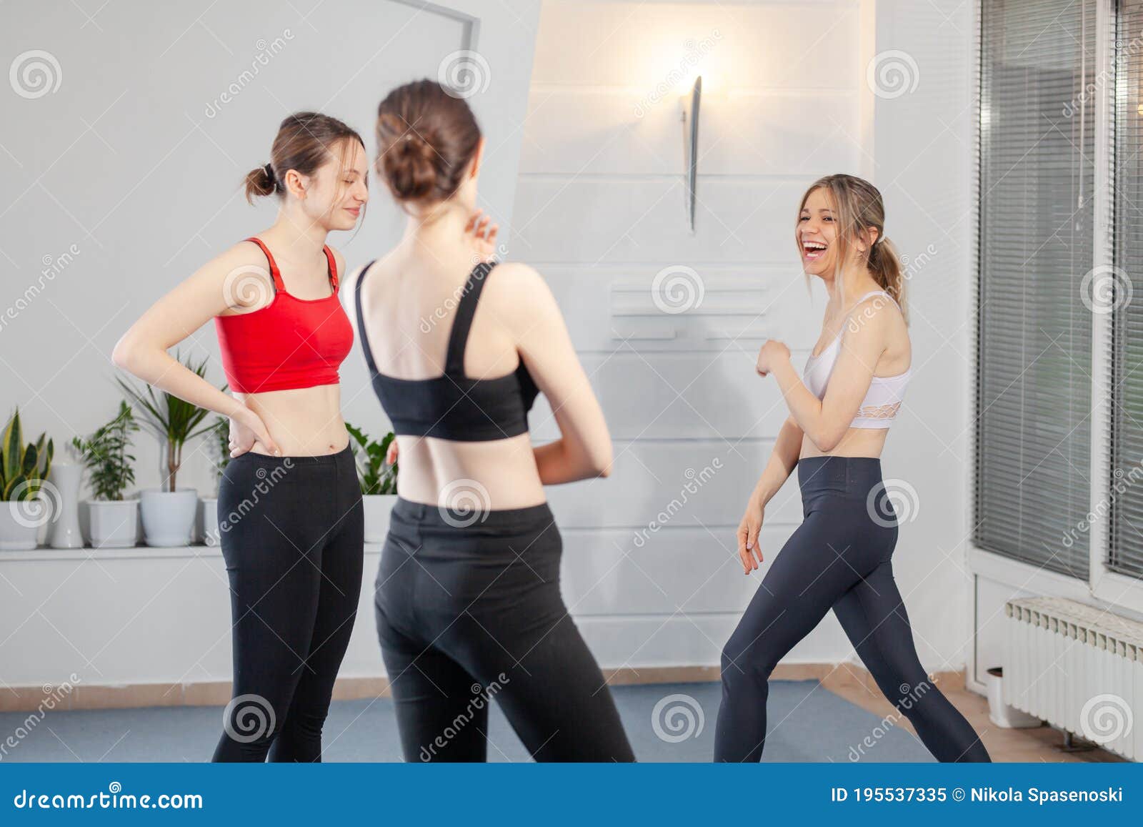 Girls And Instructor Or Mother Doing Gymnastic Exercises In Fitness