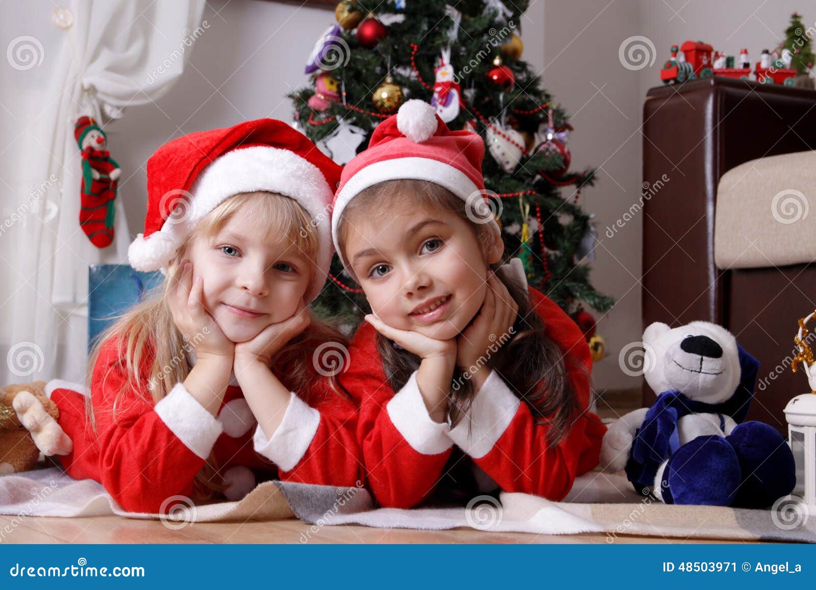 Two Girls Saw That Santa Claus Puts Presents Under The Christmas Tree ...