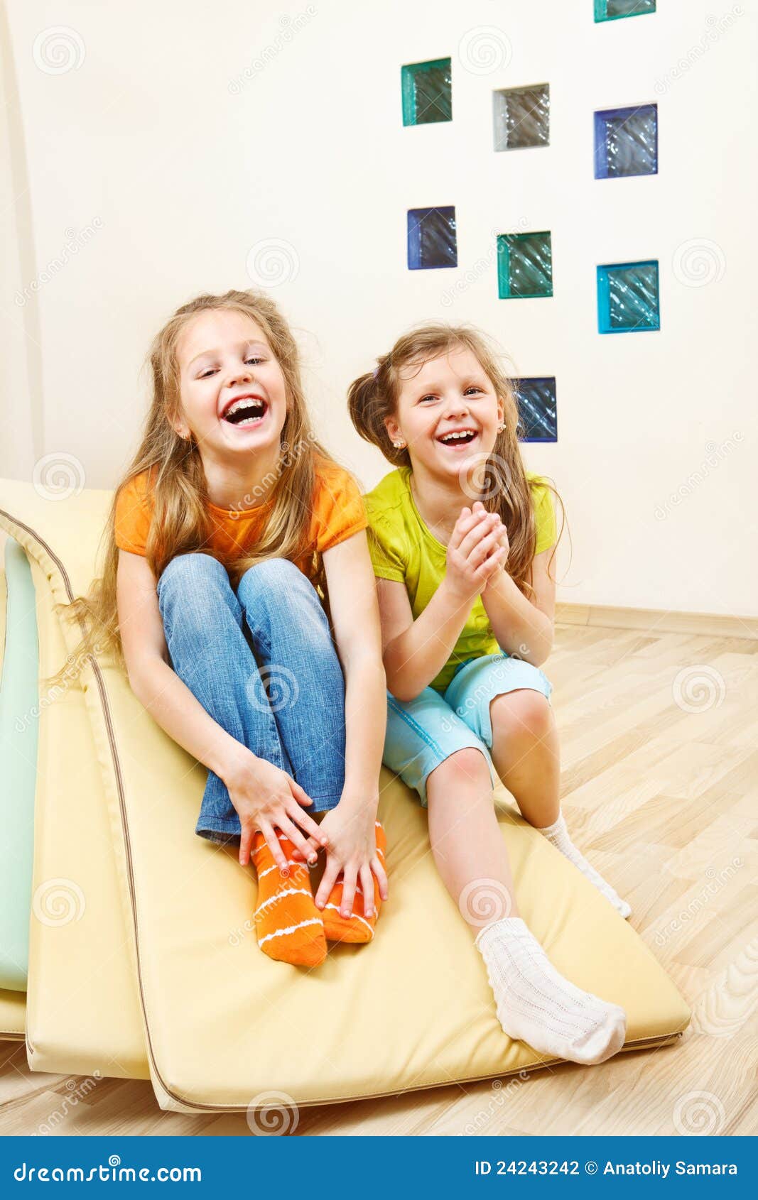 Girls sit on tumbling mats stock photo. Image of color - 24243242
