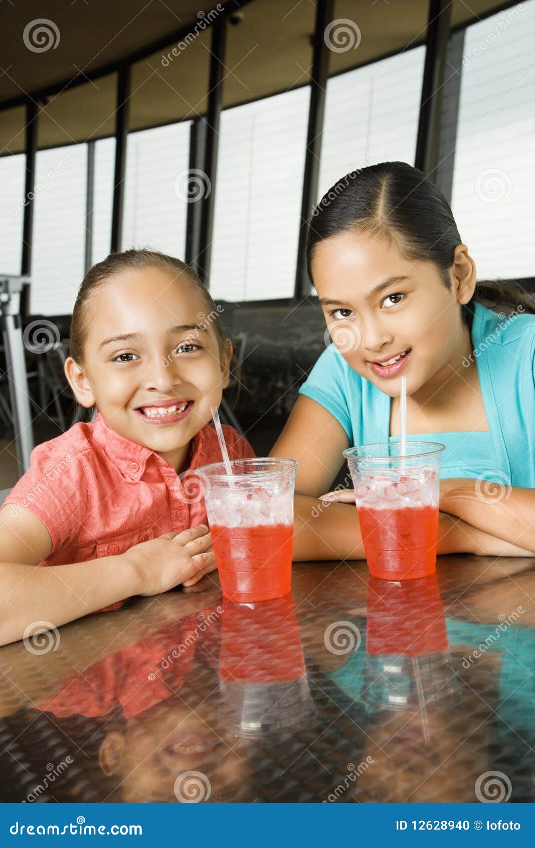Girls Sitting and Smiling with Drinks Stock Photo - Image of ethnic ...