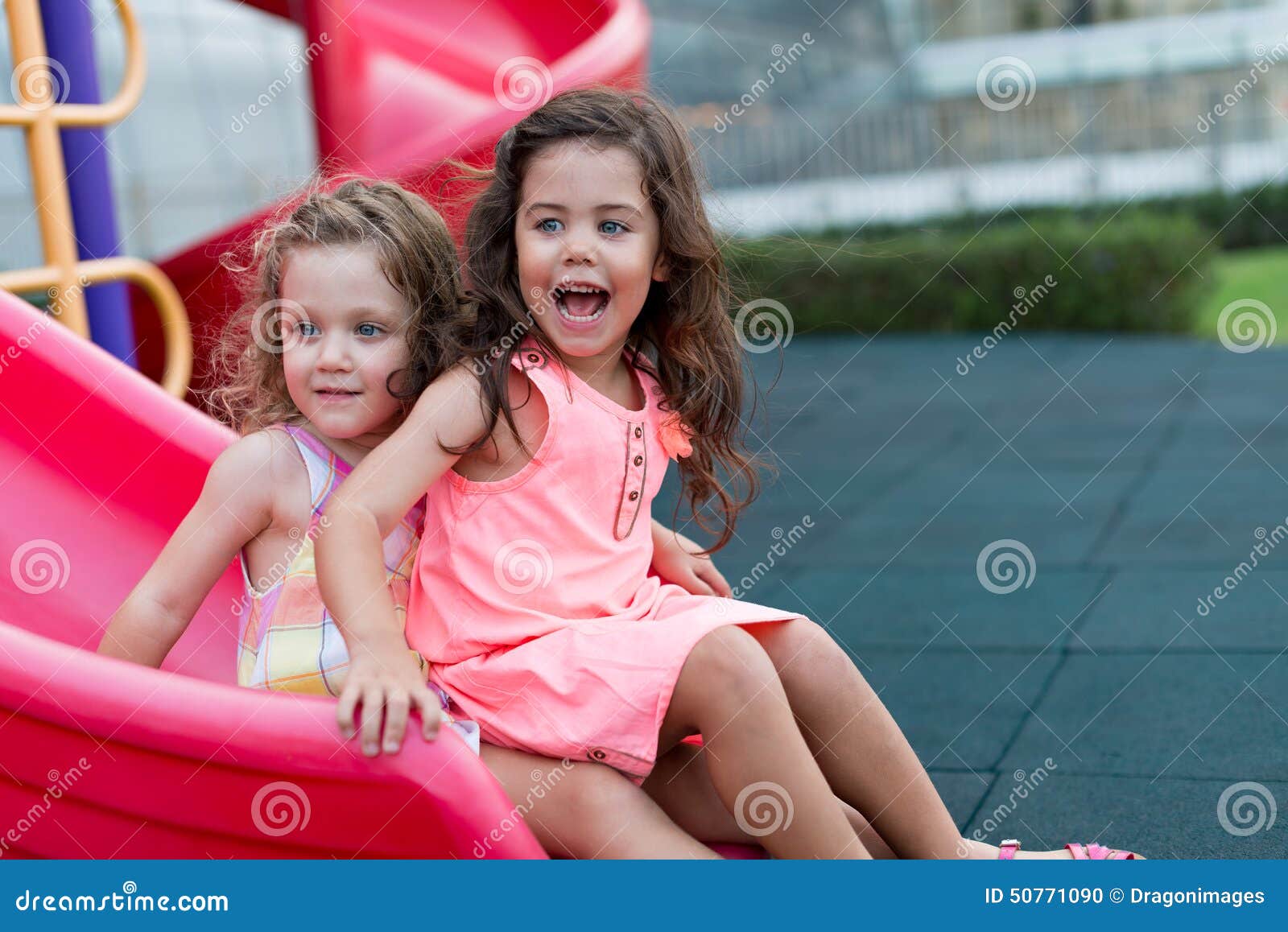 Girls on the slide stock photo. Image of outdoors, happy - 50771090