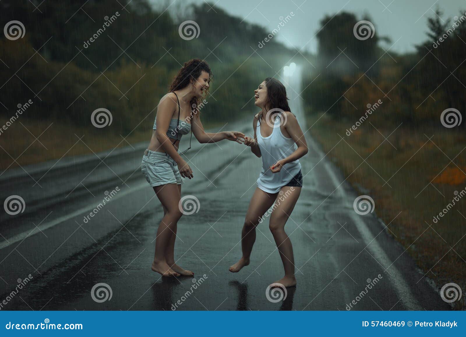 Girls Standing in the Rain on Roadway. Stock Image - Image of merriment ...