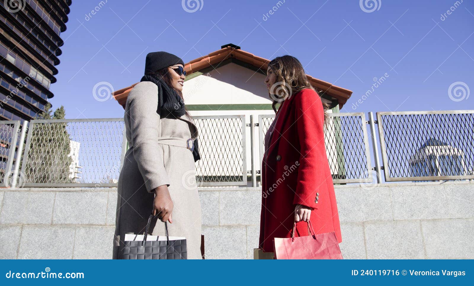 Girls Talking in Front of Each Other in Front of a Stand Stock Photo ...