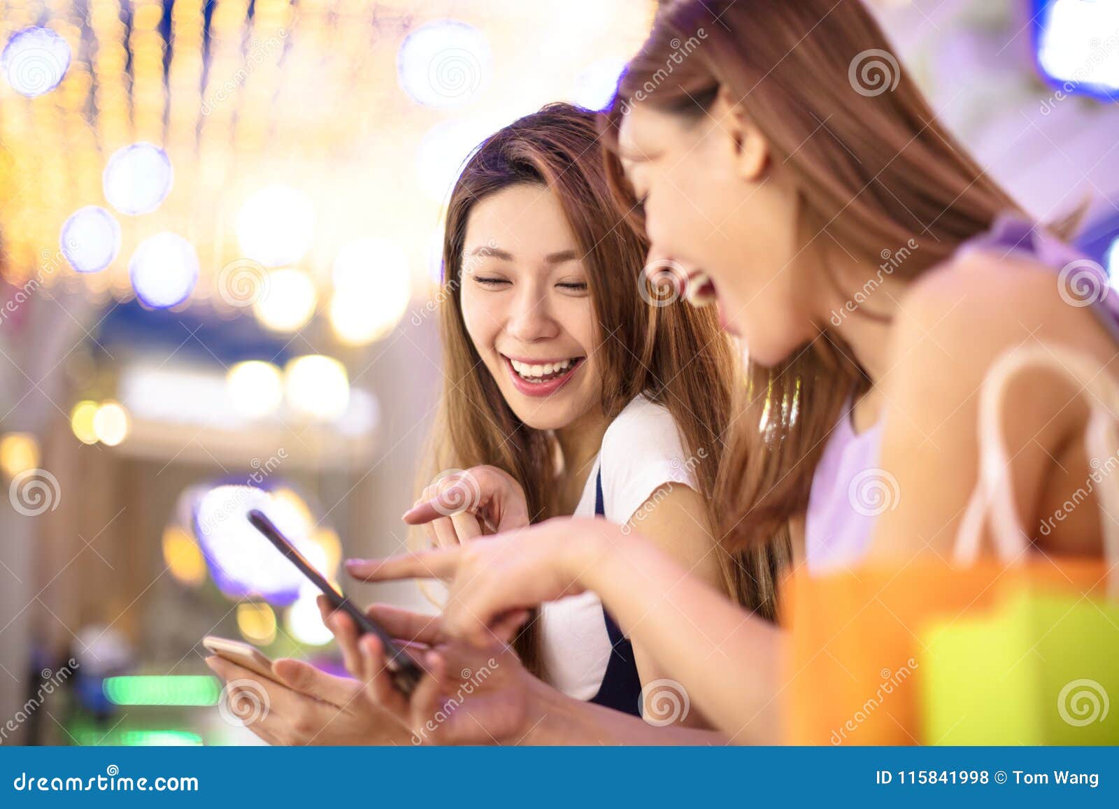 Girls Using Smart Phone in the Shopping Mall Stock Photo - Image of ...