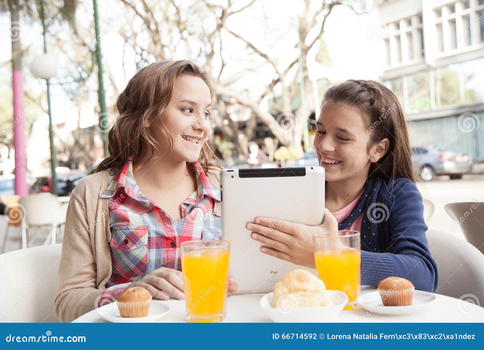 Girls Using the Tablet in the Street Stock Photo - Image of phone, cafe ...