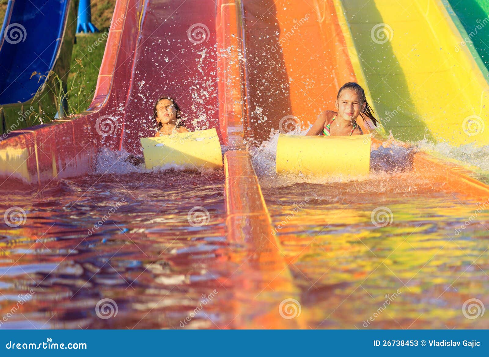 Girls on the water slide stock image. Image of outdoor - 26738453
