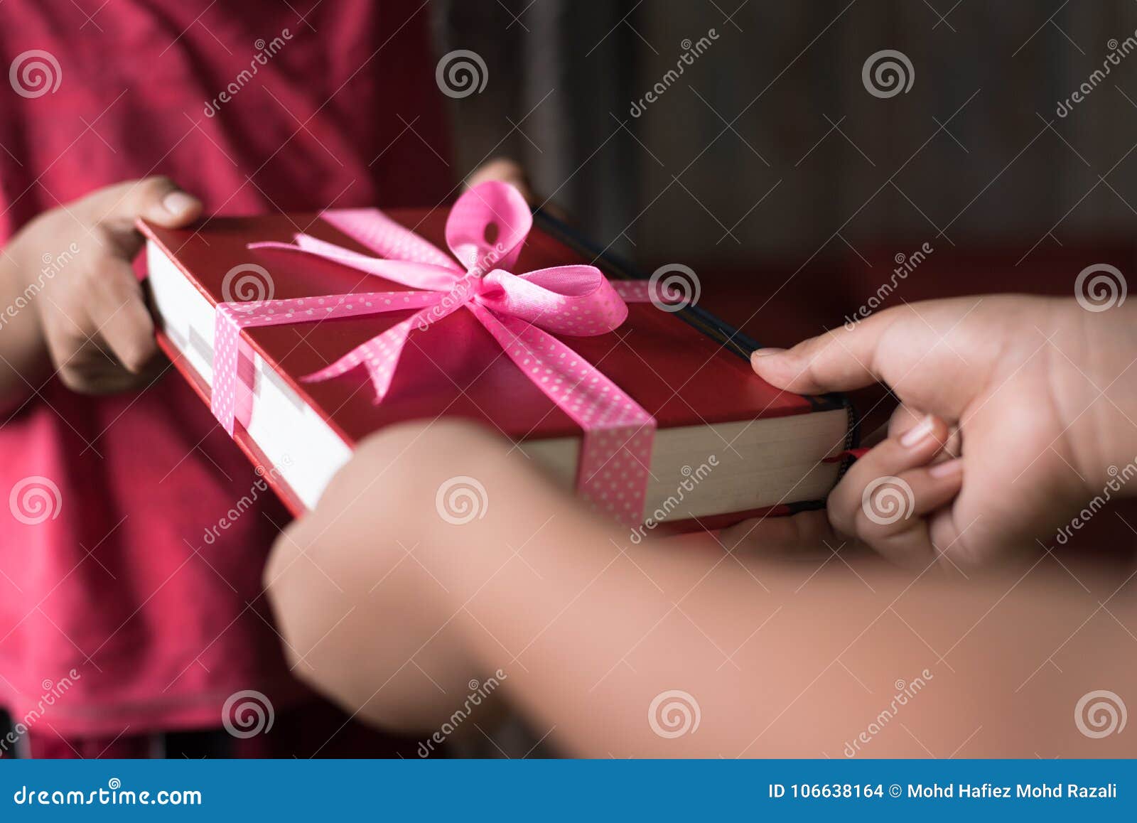 Giving a book as a present stock photo. Image of cute - 106638164