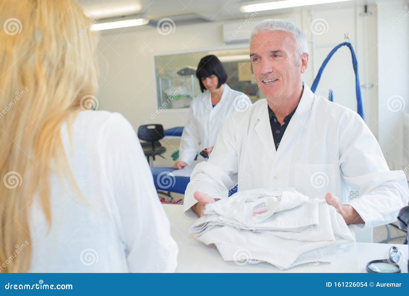 Giving Laundry Back To Customer Stock Photo - Image of code, linens ...