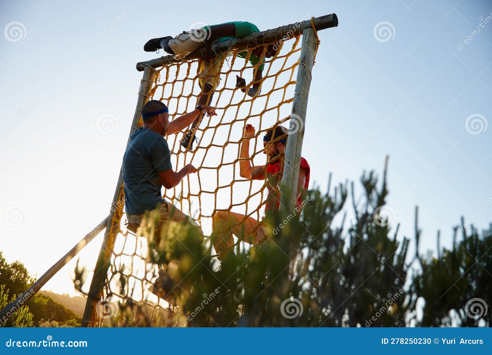 Giving it Their All. a Group of Men Going through an Obstacle Course at ...