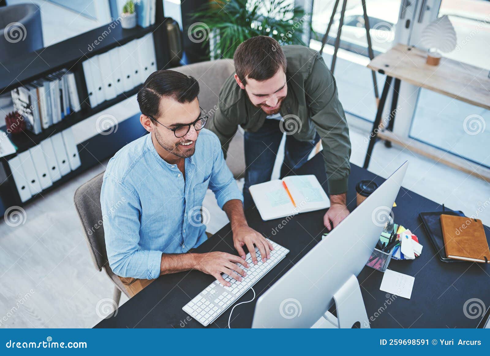 Giving Their Creative Ideas a Visual Direction. Two Young Designers ...