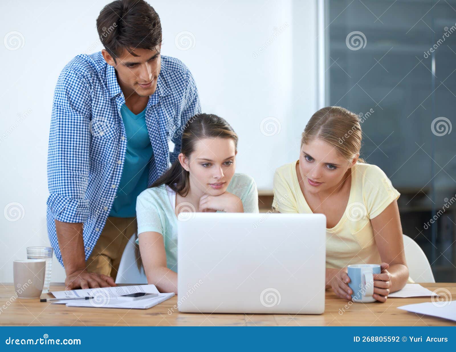 Giving Their Input. Three Colleagues Working in an Office. Stock Photo ...