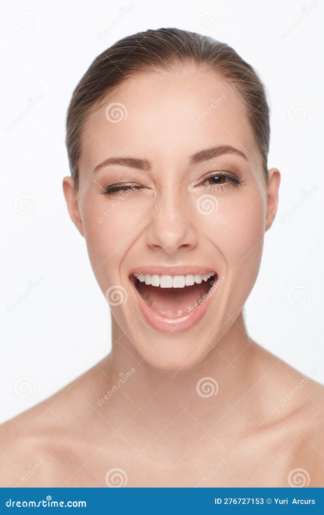 Giving You A Wink A Beautiful Young Woman Winking Playfully At The