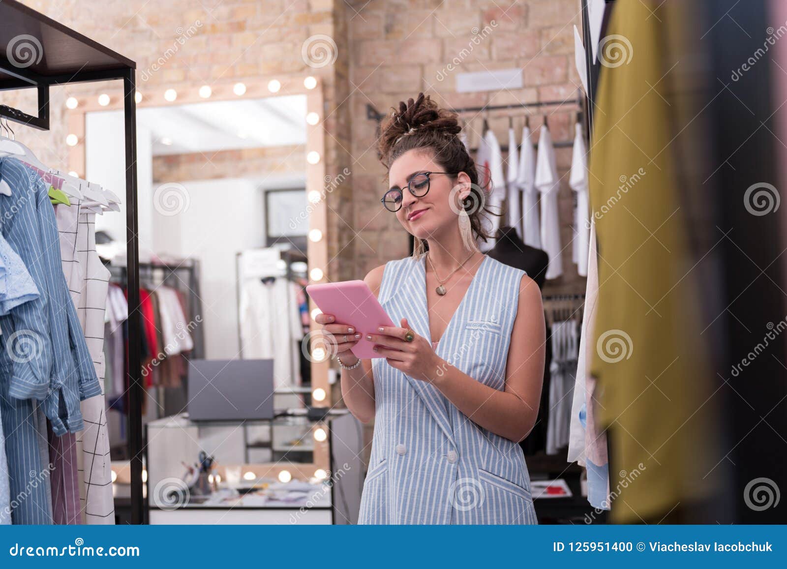 Glad Female Shop Assistant Checking Available Sizes Stock Photo - Image ...