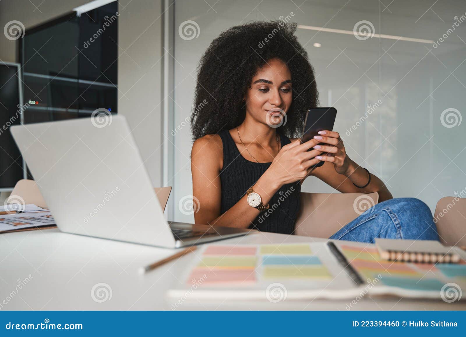 Calm Office Worker Using Her Smartphone and Smiling Stock Photo - Image ...