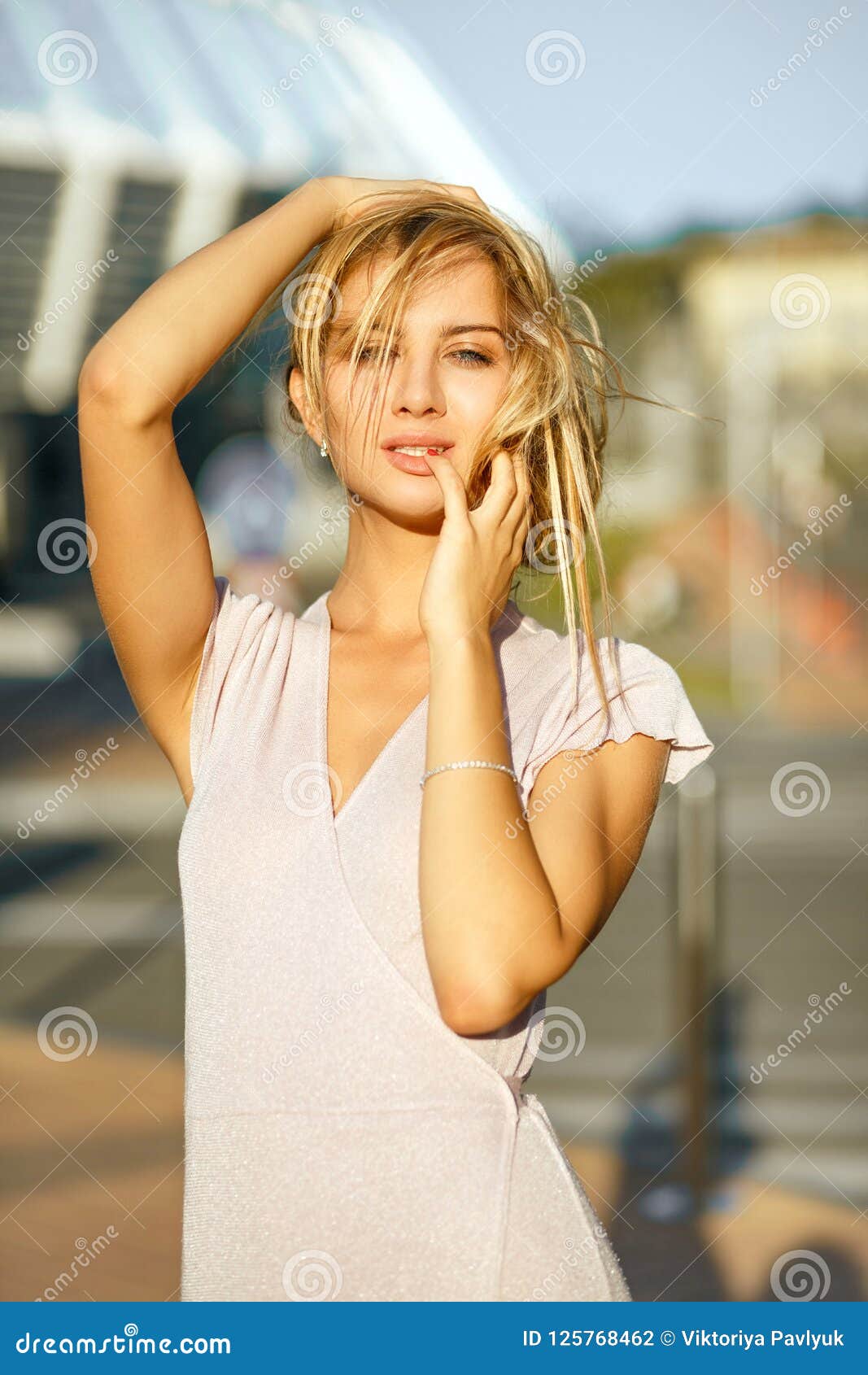 Glamor Blonde Girl With Long Hair Posing At The Background Of St Stock