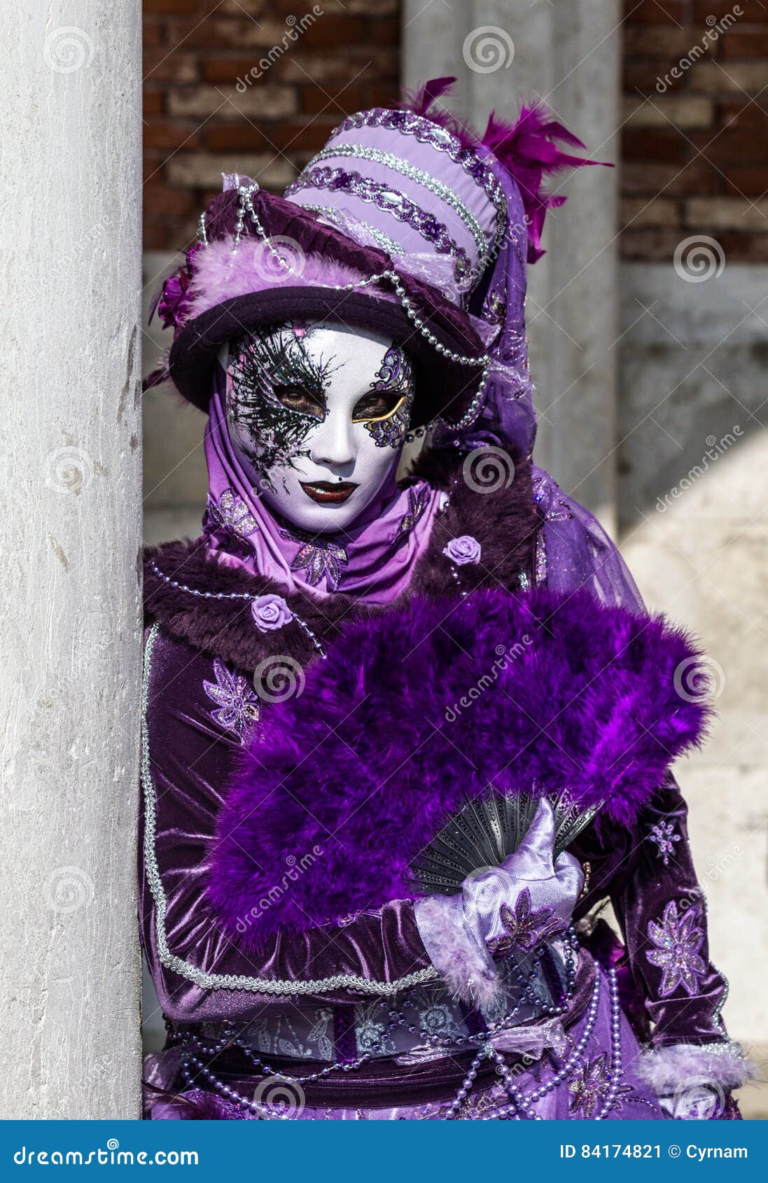 Glamorous Woman Performer With Purple Costume And Venetian Mask During