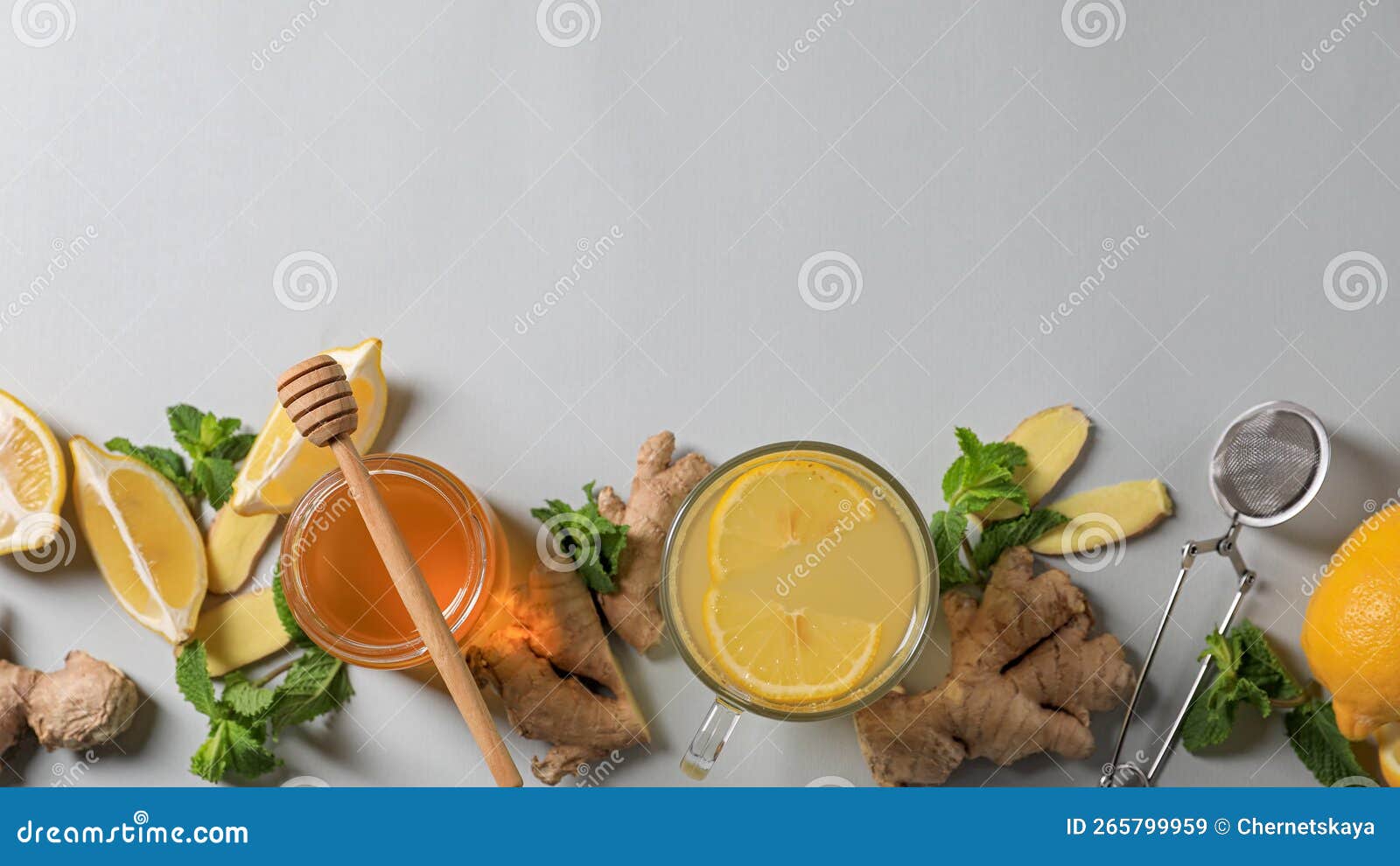 Glass of Aromatic Ginger Tea and Ingredients on Light Grey Background ...