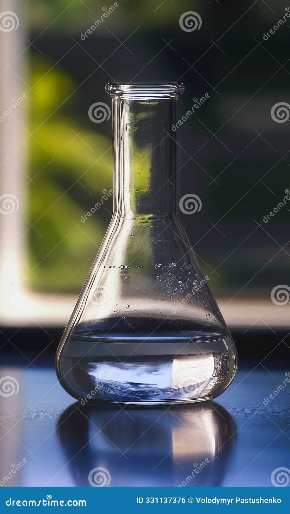 A Glass Beaker Filled with Water Sitting on Top of a Table Stock Photo ...