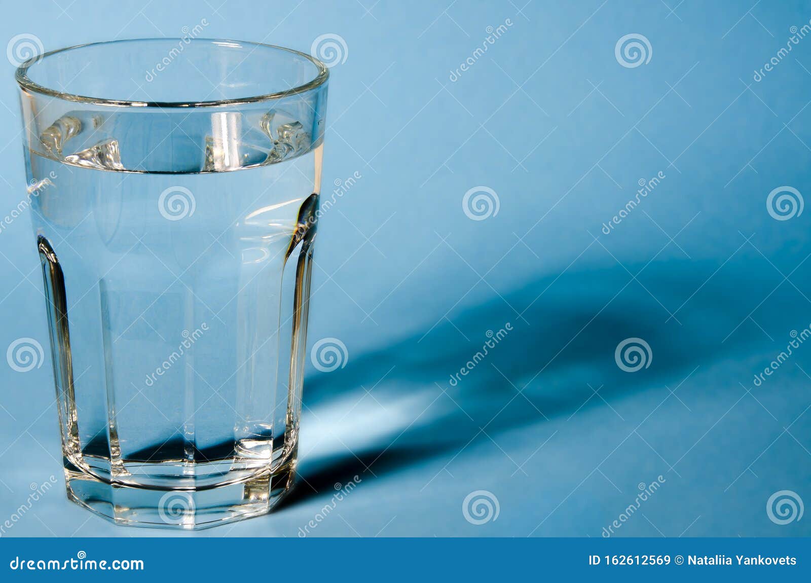 Water Glass with Strong Shadows on White Background Stock Image - Image ...