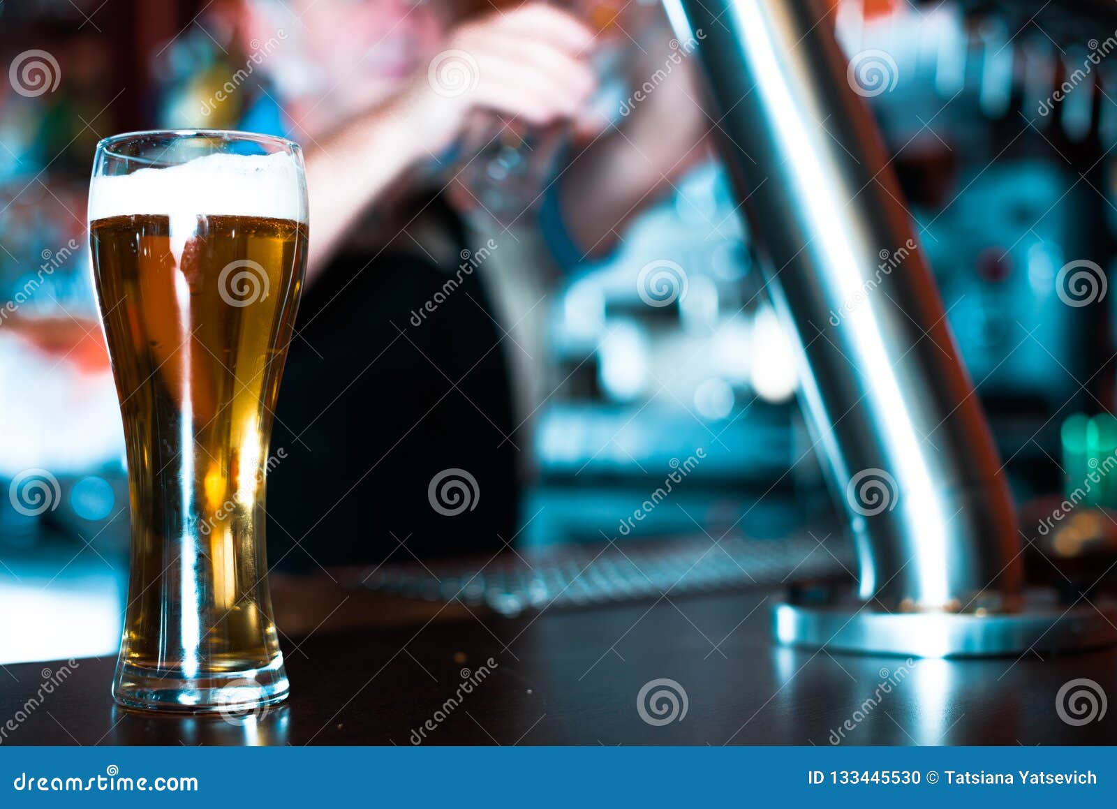 Glass of Beer on Bar Counter Against Background of Friendly Bart Stock ...