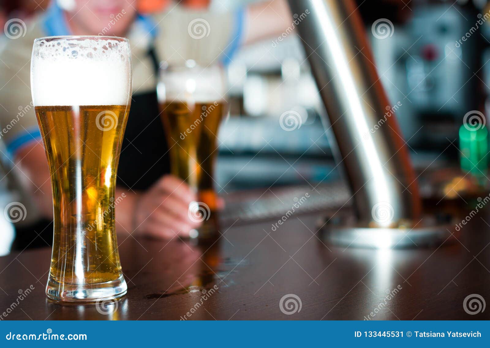 Glass of Beer on Bar Counter Against Background of Friendly Bart Stock ...