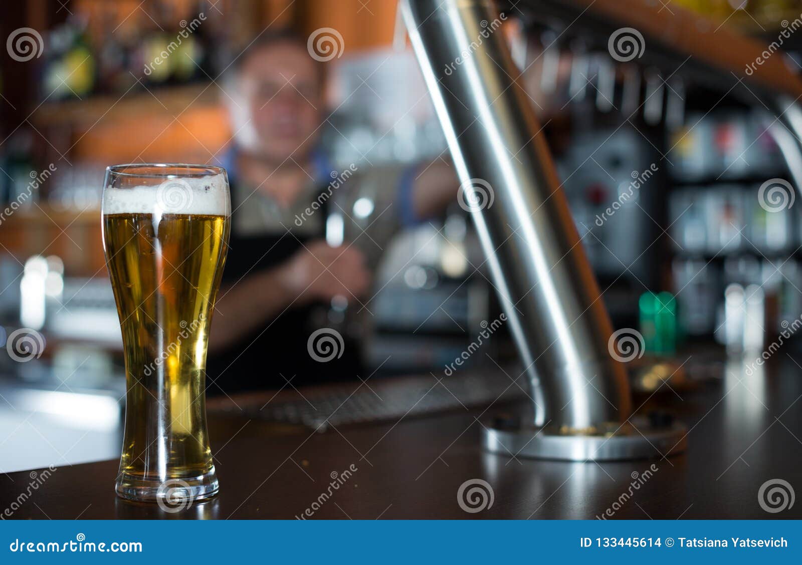 Glass of Beer on Bar Counter Against Background of Friendly Bart Stock ...