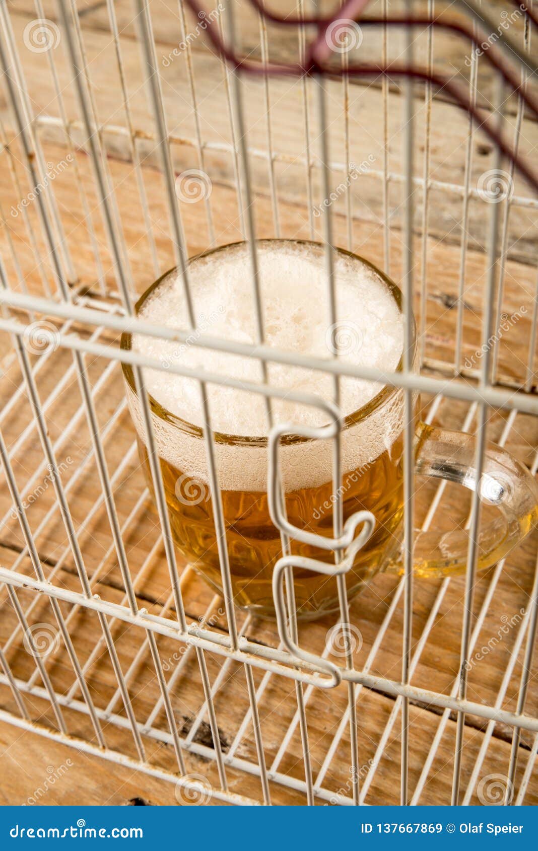 Glass of beer in a cage stock image. Image of drink - 137667869