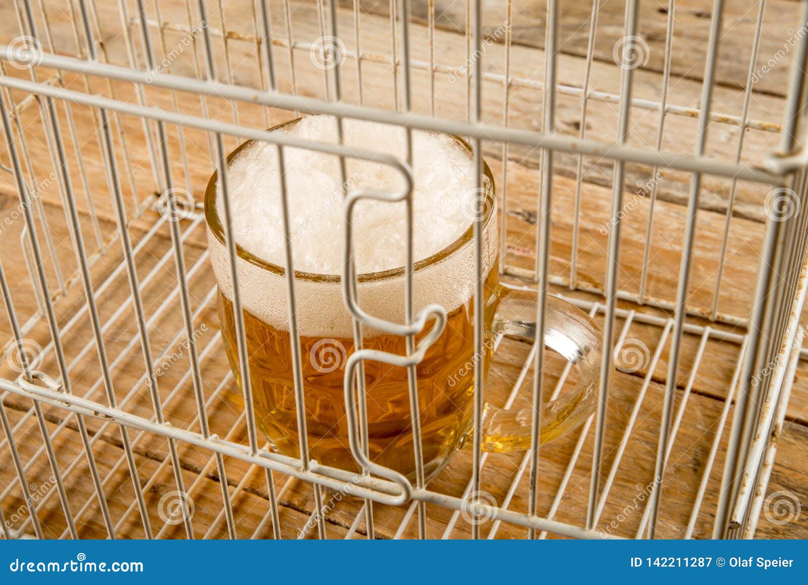 Glass of beer in a cage stock image. Image of alcoholic - 142211287