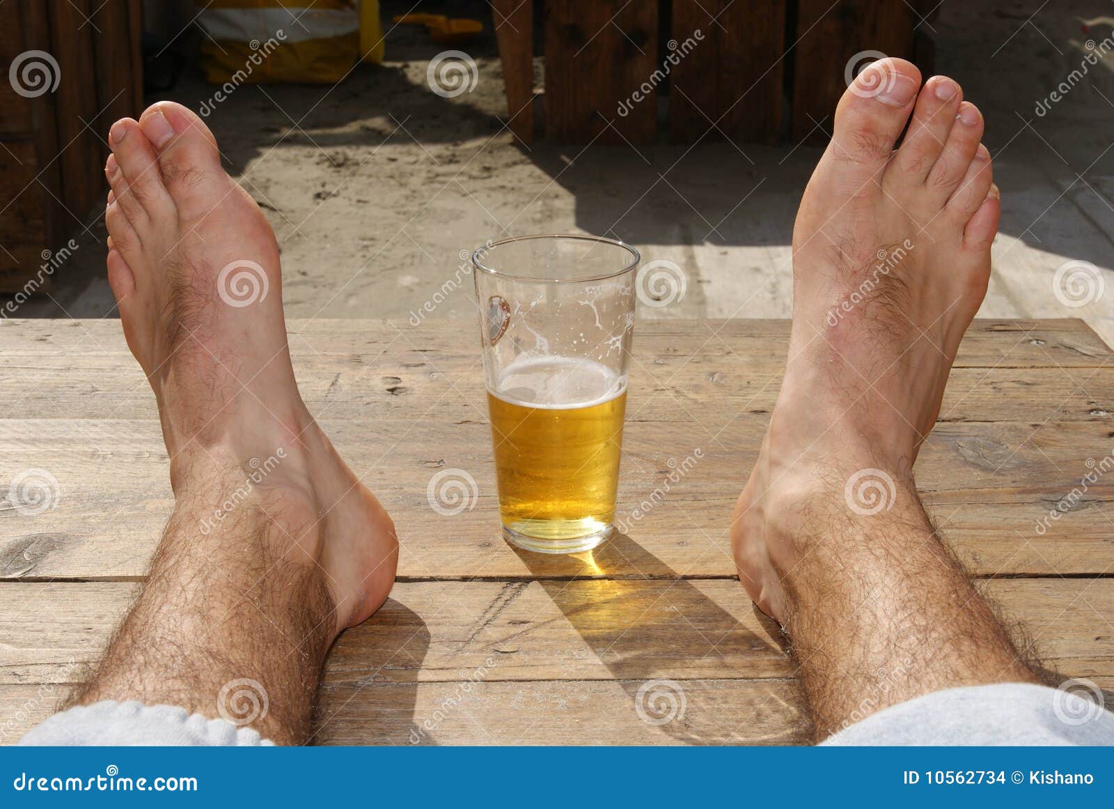 Glass with Beer between Feet Stock Photo - Image of alcohol, resting ...
