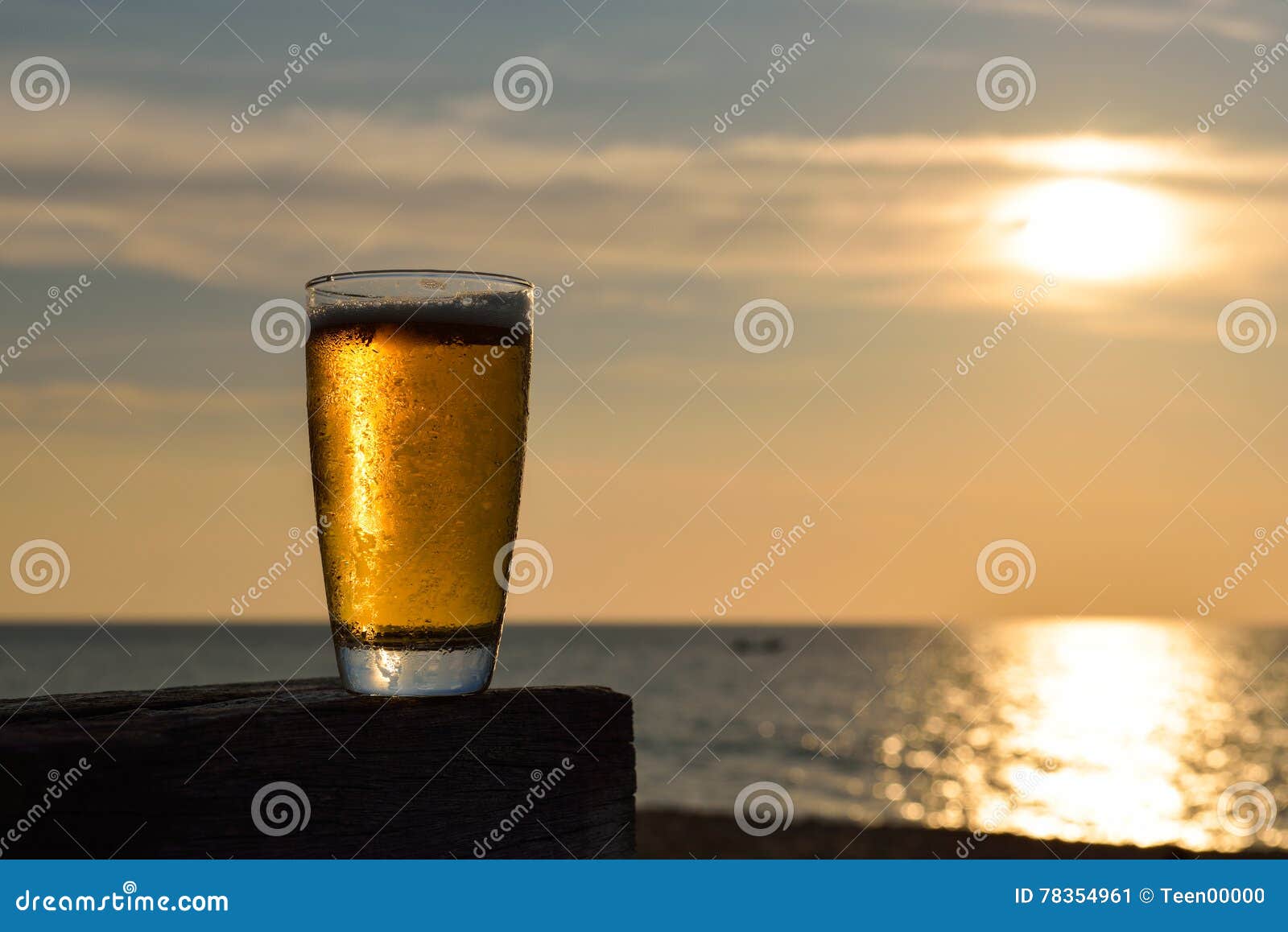 Glass of beer on a sunset stock image. Image of sunrise - 78354961