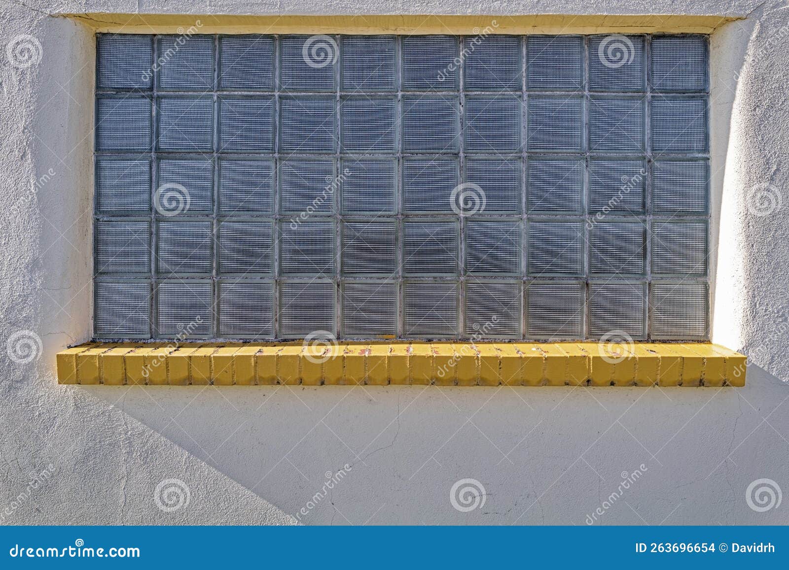 A Glass Block Window is Installed on the Plaster Wall of a Building ...