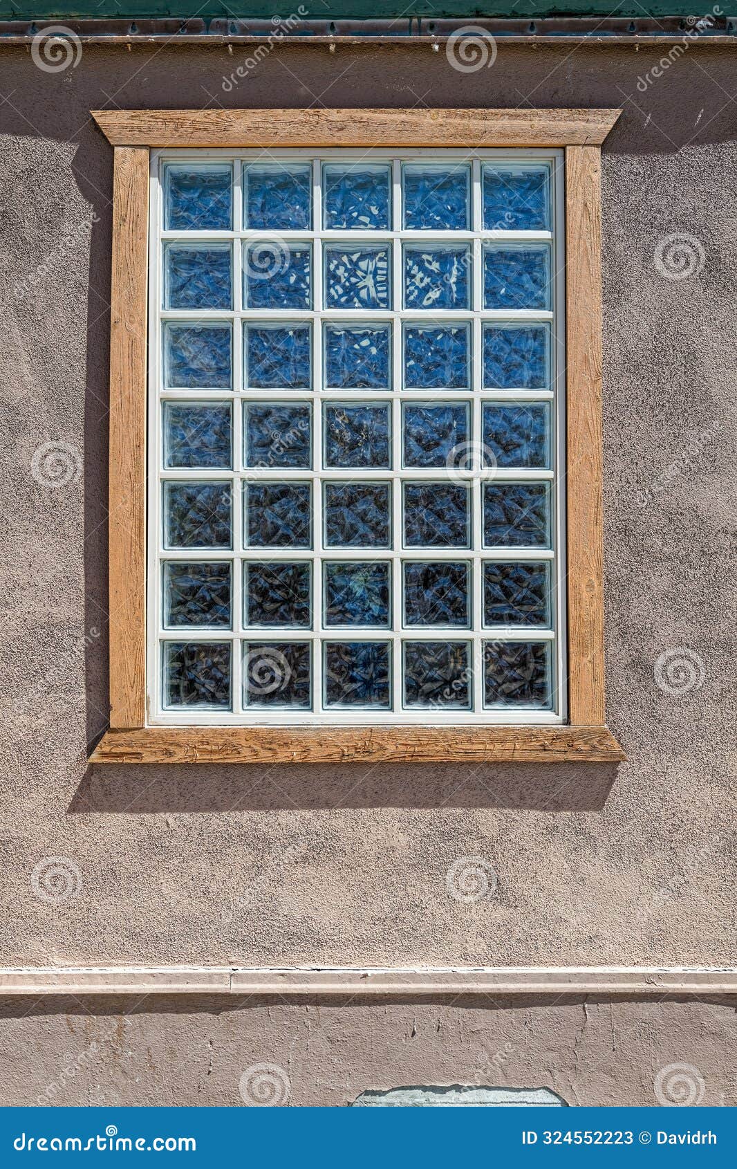 A Glass Block Window in a Wood Frame on an Exterior Wall of a Building ...
