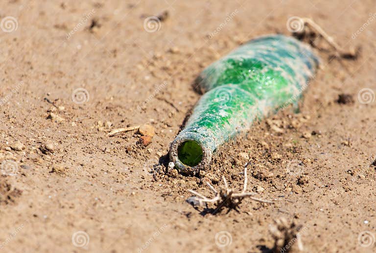 Glass Bottle in the Ground on the Beach Stock Photo - Image of bottle ...