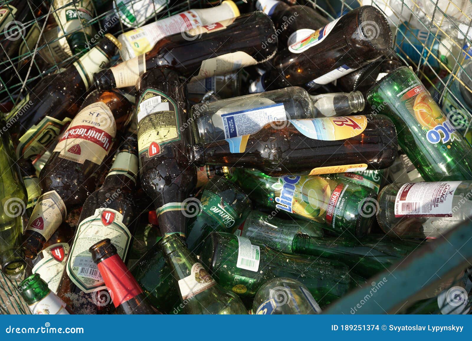 Glass Bottles From Beer And Lemonade In A Trash Can Close Up Shot Sorting And Recycling