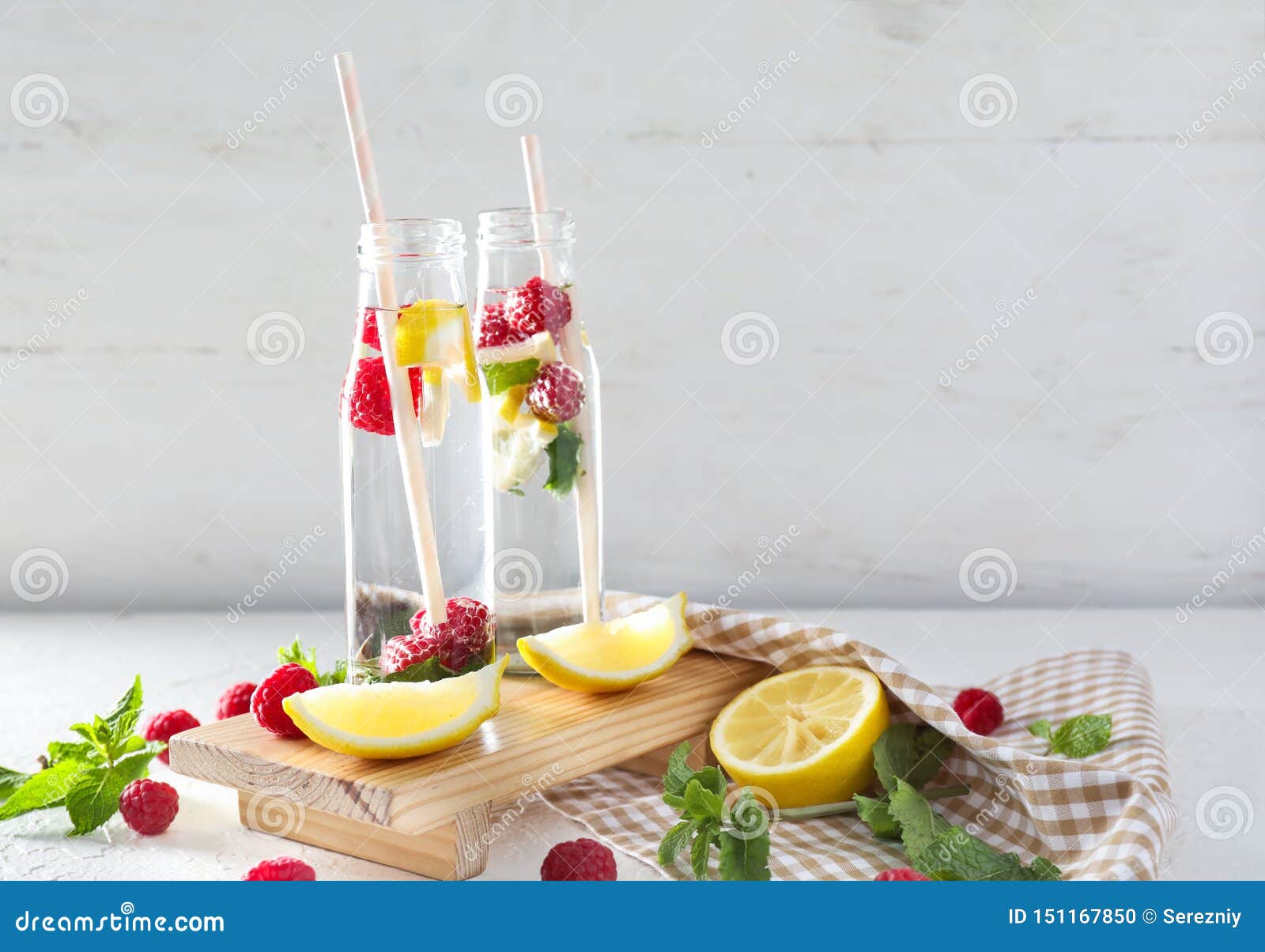 Glass Bottles of Fresh Raspberry Mojito on White Table Stock Photo ...