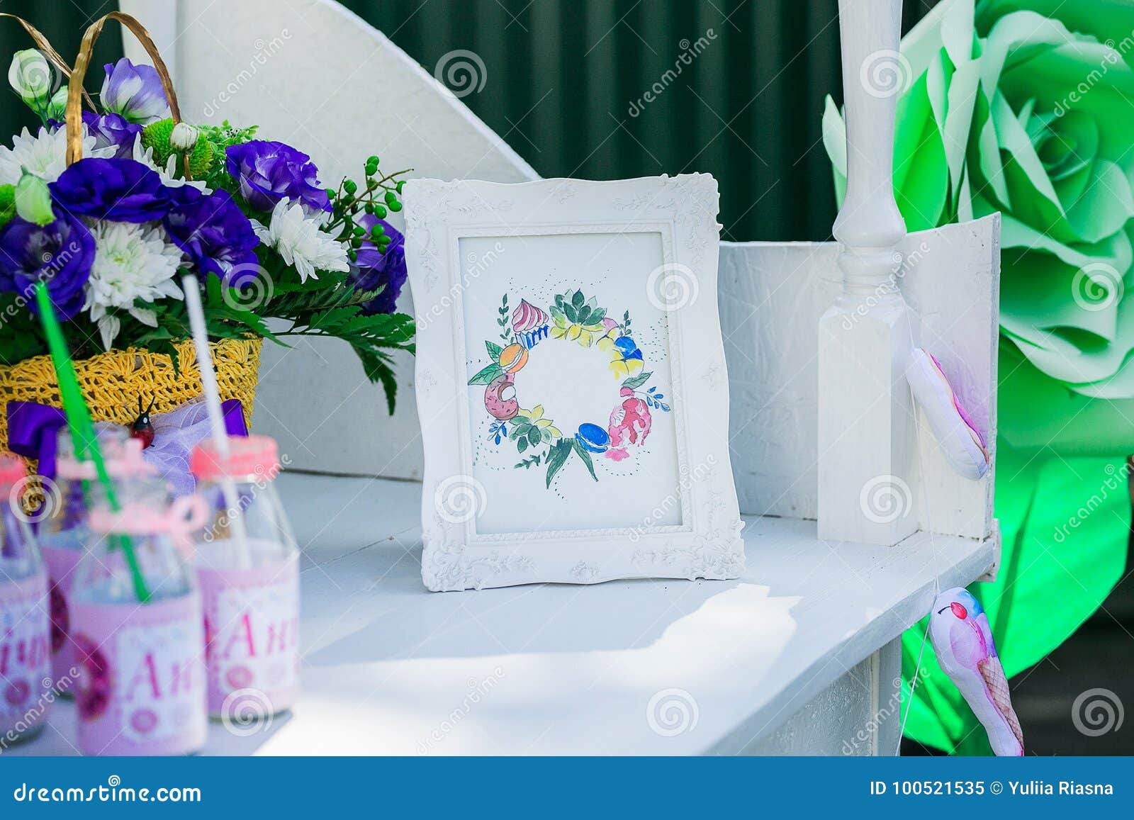 A Glass Bottles on a Kandi Bar. Frame on the Table with Flowers and ...