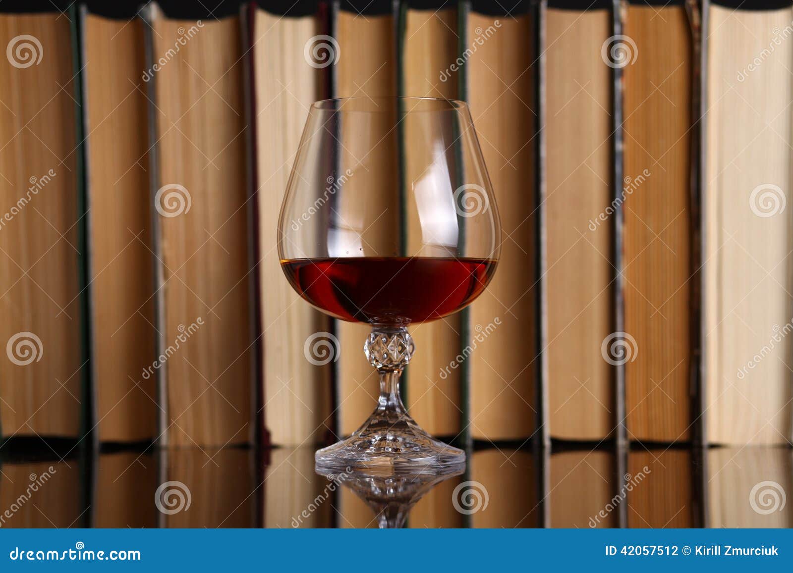 Glass of brandy and books stock photo. Image of drink - 42057512