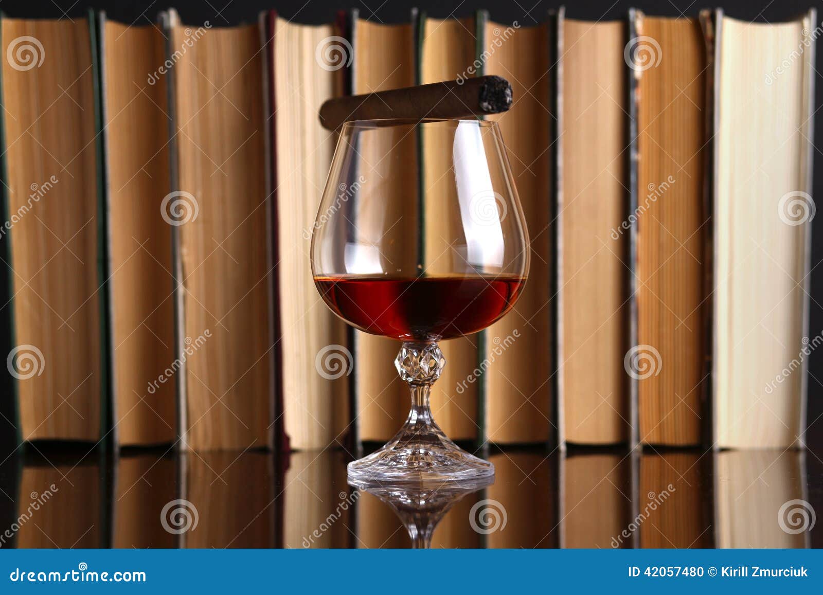 Glass of brandy and books stock photo. Image of advertising - 42057480