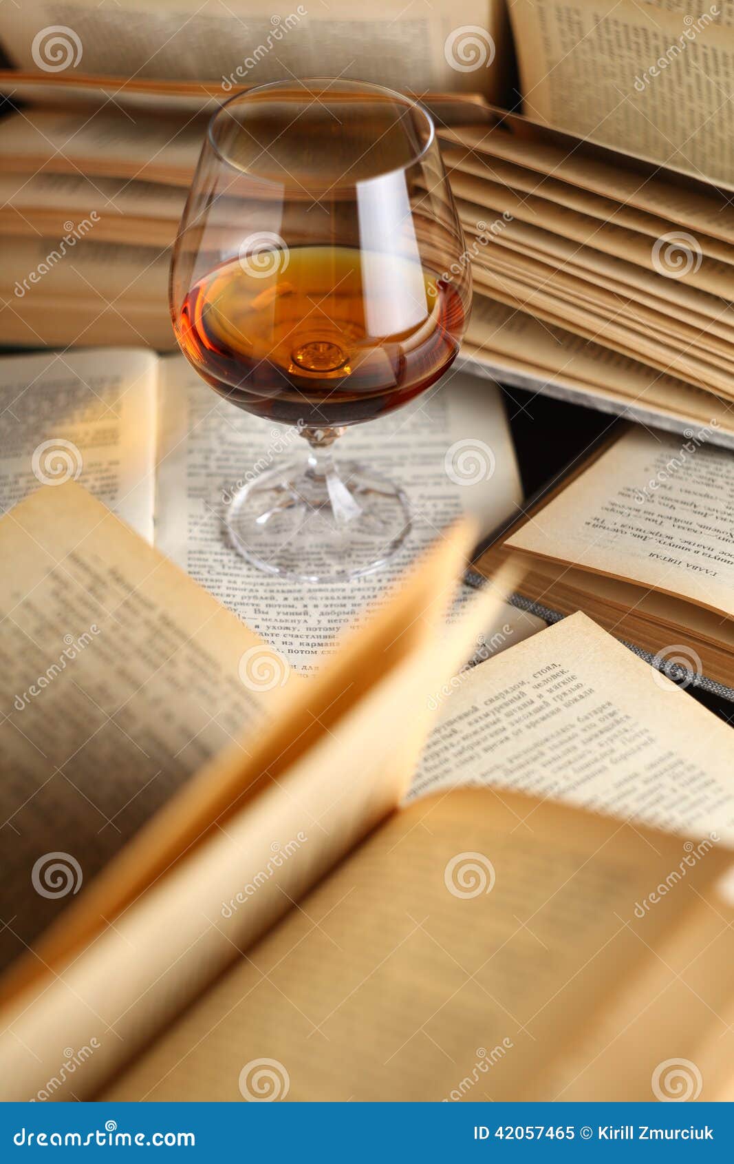 Glass of brandy on books stock image. Image of taste - 42057465