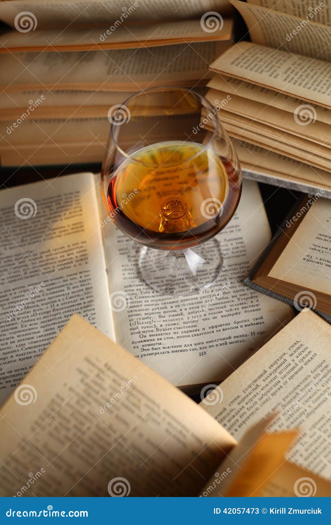 Glass of brandy on books stock image. Image of alcohol - 42057473